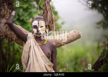 Portrait of young Suri / Surma woman with ritual scarification on chest ...