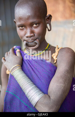 Portrait of young Suri / Surma woman with ritual scarification on chest ...