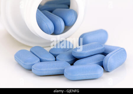 White caplet on blue caplets background Stock Photo - Alamy