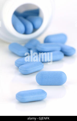 White caplet on blue caplets background Stock Photo - Alamy