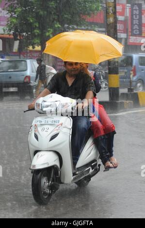 Allahabad, India. 16th Aug, 2016. Commuters use plastic sheet to be ...