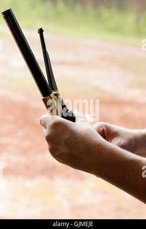 A man loading an antique black powder muzzle loading shotgun on a game ...