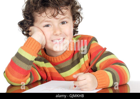 Adorable caucasian boy student writing on notebook studying at ...