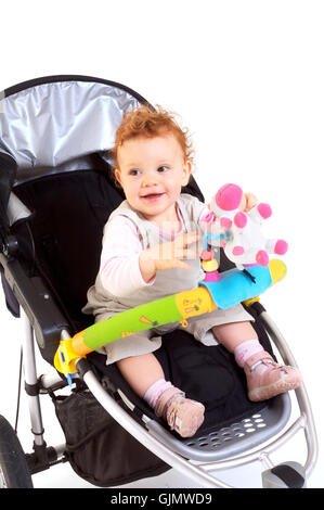 A girl on a baby stroller plays with Pokemon character Pikachu during a ...