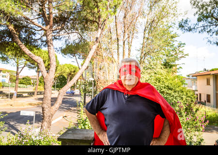 smiling man in superhero cape with rag and cleaner Stock Photo - Alamy