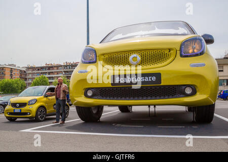 A giant Smart car next to a standard size Smart car in Rome Featuring ...
