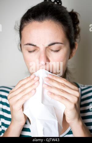 Young woman sneezes has flu catarrh ill sick disease treatment cold ...
