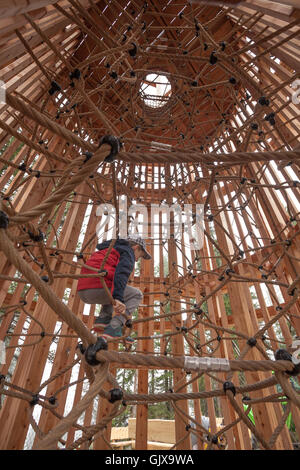 Boy climbing rope tower in Spruce Tree Castle at Rosenalm park near ...