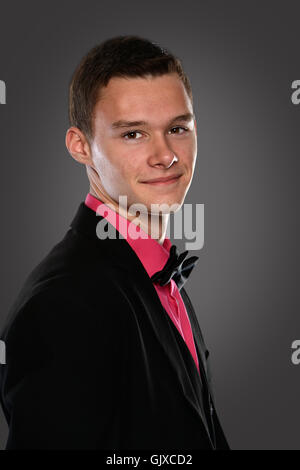 Young adult man over brick wall holding blackboard with happy face ...