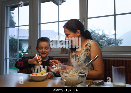Boy and mom having fun cooking together Stock Photo - Alamy