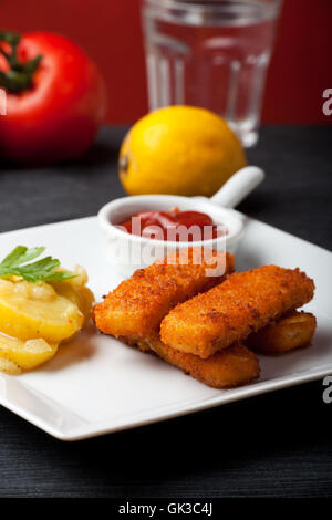Fish fingers with potato salad Stock Photo - Alamy
