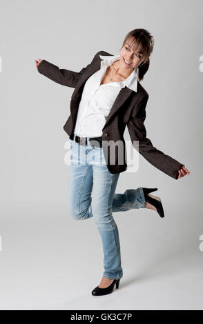 Woman balancing on one leg in a dynamic pose Stock Photo - Alamy