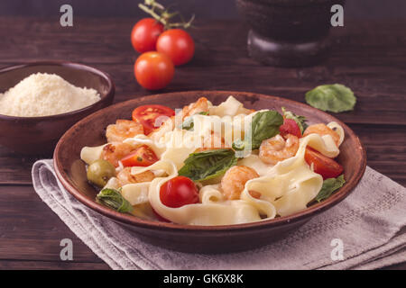 Fettuccine pasta with shrimp, cherry tomatoes, sauce, spices and herbs ...