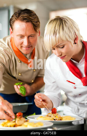 two cooks team in restaurant kitchen Stock Photo - Alamy