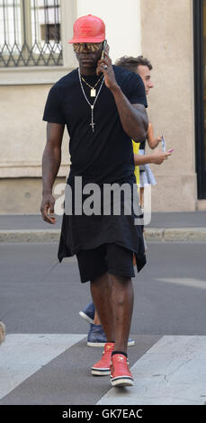 Mario Balotelli and his brother Enock Barwuah in downtown Milan ...
