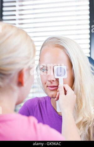 Young woman at eyesight inspection at optician Stock Photo - Alamy
