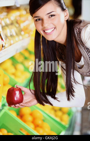 Charming brunette showing an apple Stock Photo - Alamy