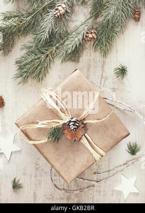 Top view on Christmas gift wrapped in craft gift paper decorated with ...