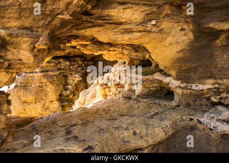 Caves eroded from cliffs of yellow coloured Magnesian Limestone rock at ...