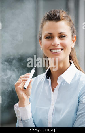 Happy laughing woman smoking a cigarette Stock Photo - Alamy