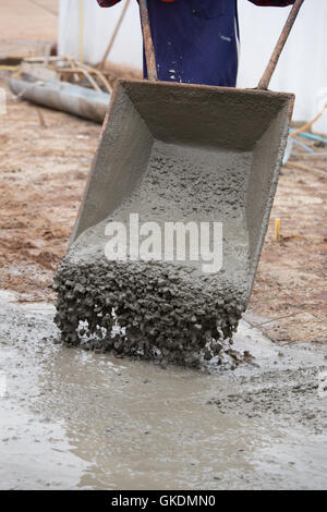 worker pouring cement from cart to floor at construction site Stock ...