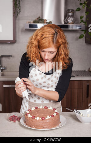 Decorating a cake for Valentines day. Handmade pie with cream cheese ...