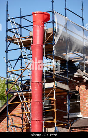 Rubbish Chute On Building Site taking the waste into a skip at the ...