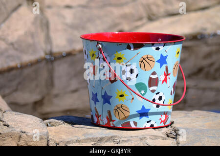 Bucket on the Rock Wall Stock Photo - Alamy