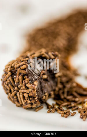 A top view of chocolate Brazilian Brigadeiro and Beiginho on a cutting ...