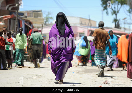 A Somali woman walks down the street in Mogadishu's Hamar Weyne market ...