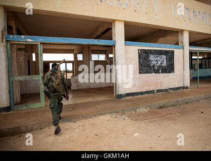 A Somali National Army soldier walks through scrubland during a joint ...