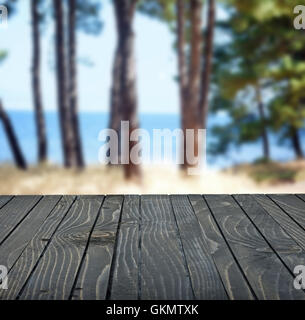 Empty wooden table and green spring leaves in background Stock Photo ...