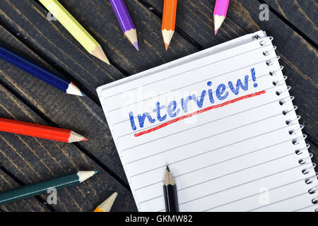 Interview text on notepad and colorful pencils Stock Photo - Alamy