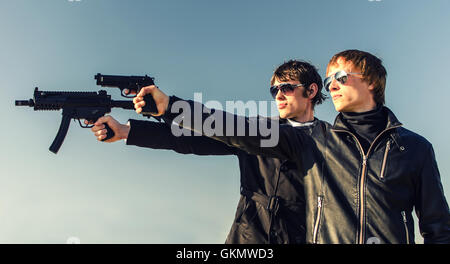 Portrait of two tough guys with guns Stock Photo - Alamy