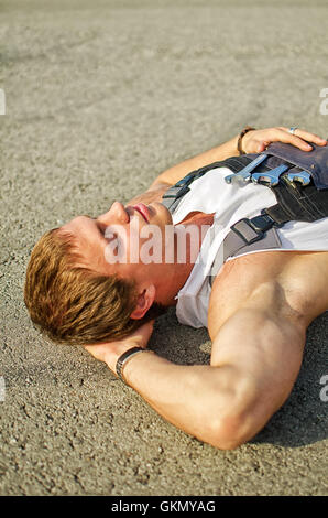 Tired mechanic resting on the road Stock Photo - Alamy