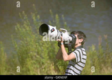 A photographer using a Canon Camera and lens Stock Photo - Alamy