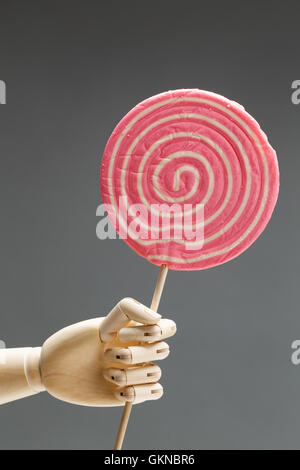 Human hand holding a robot model. shows the use of the AI system in ...