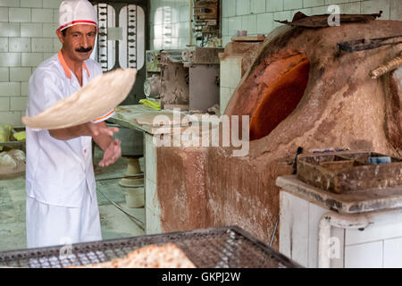 Iranian baker baking beautiful Persian Taftoon Bread using Tandoor Oven ...