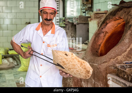 Persian baker baking beautiful Persian Taftoon Bread using Tandoor Oven ...