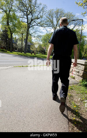 Pensive black man walking outside in city thinking by himself during ...