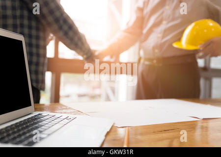 architect engineer shaking hands beside window - business teamwork ...