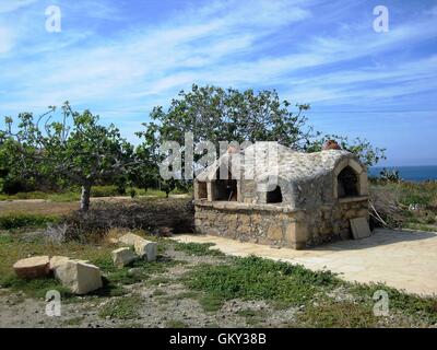 Traditional outdoor Greek and Cyprus kleftiko oven with burning fire ...