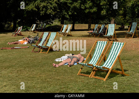 London, UK. 24th Aug, 2016. A sunbather in Kensington Gardens during ...