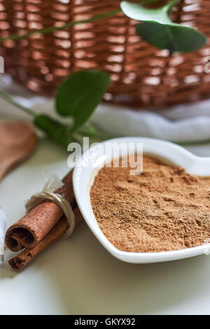 Cinnamon sticks and bowl with powder on wooden background Stock Photo ...