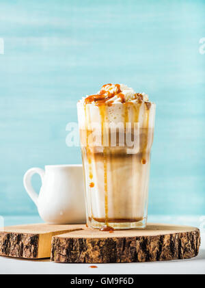 Latte macchiato with whipped cream, serving silver spoon Stock Photo ...