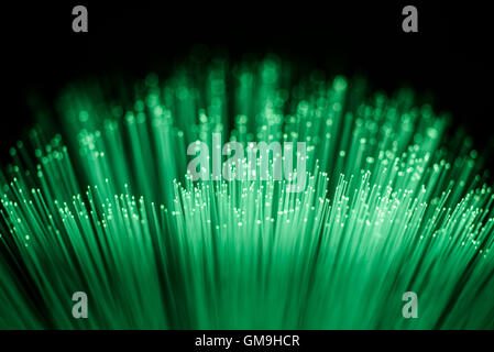 Bunch of glowing green fiber optic cables on black background Stock ...