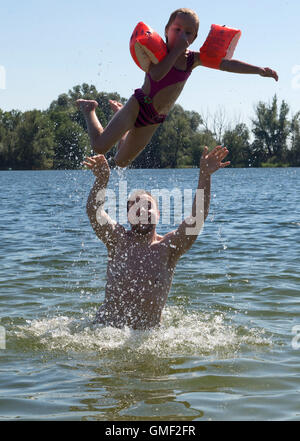 Berlin, Germany. 25th Aug, 2016. People walk across a street in City ...