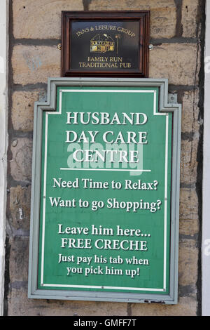 A sign for a Husband Creche, outside a pub Stock Photo - Alamy
