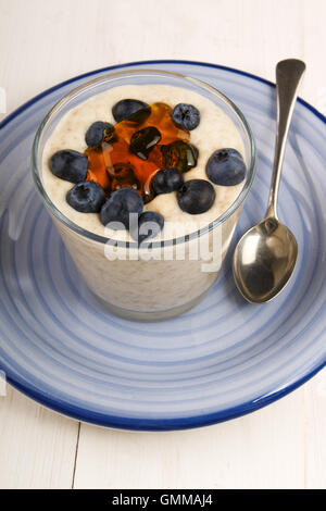 Cooked steel cut oatmeal in a bowl with blueberries, raspberries, and ...