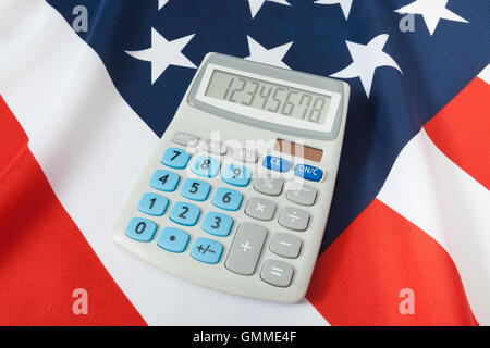 Part of studio shoot ruffled national flag with calculator over it ...